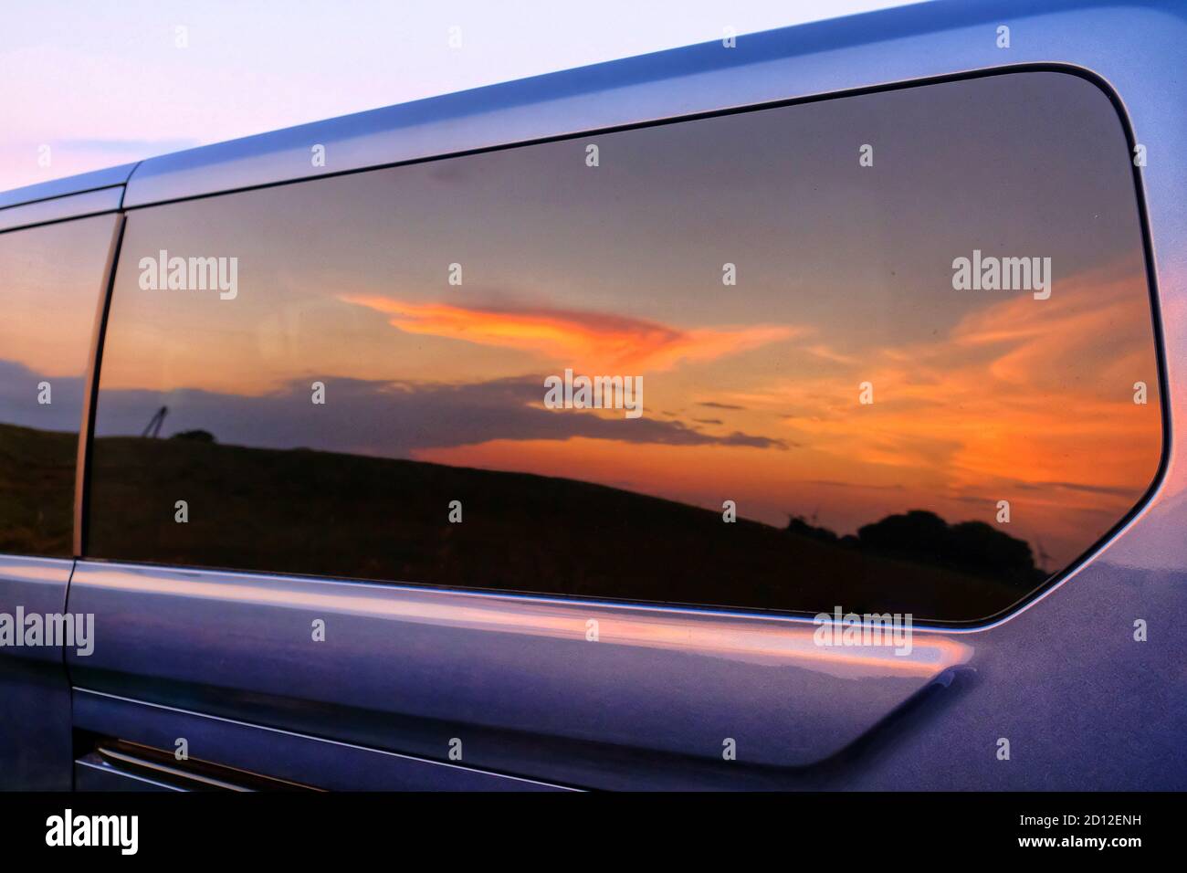 Beautiful sunset reflected on car side window Stock Photo - Alamy