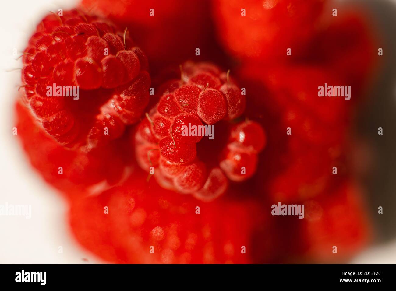 Beautiful raspberries in triangle shape lies isolated on a white ...