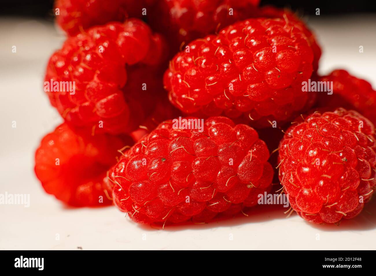Beautiful raspberries in triangle shape lies isolated on a white ...