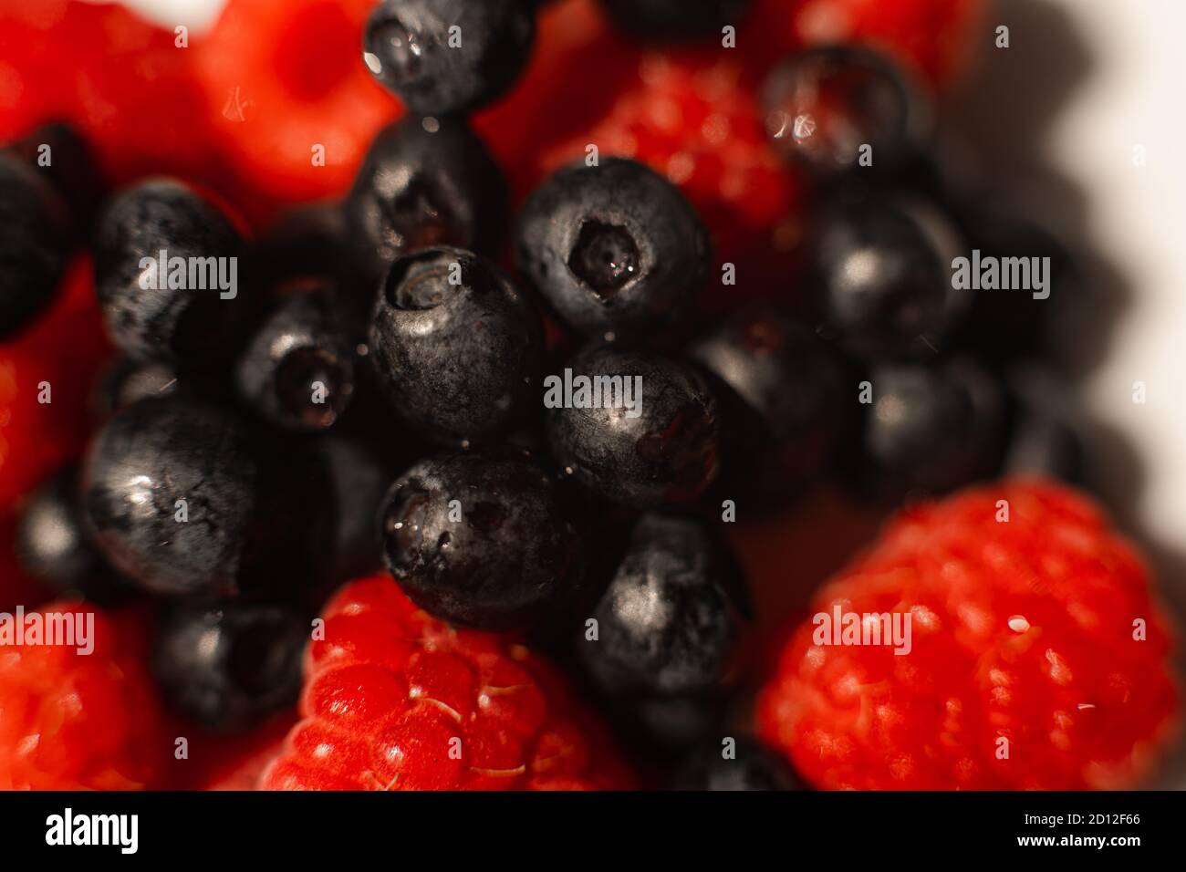 Black currant and raspberries pile Stock Photo - Alamy