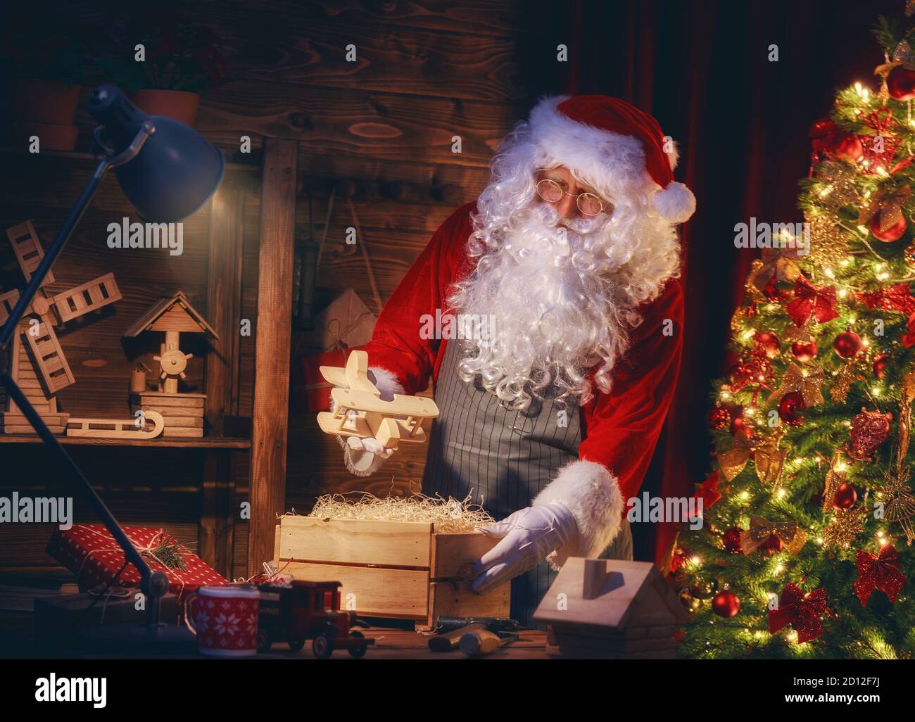 Merry Christmas and Happy Holidays! Santa Clause is preparing gifts for ...