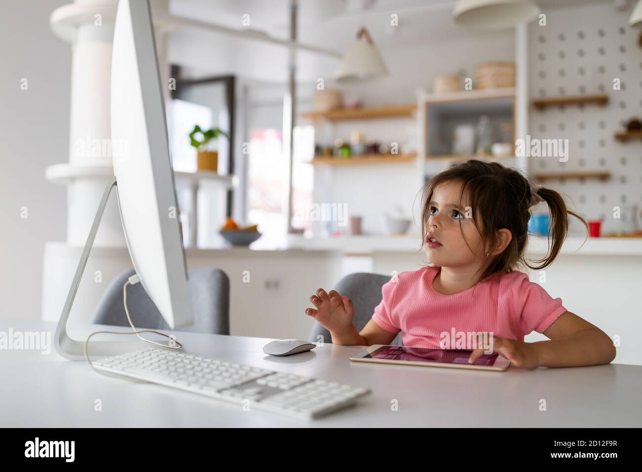 Little addicted child playing with technology devices at home Stock ...
