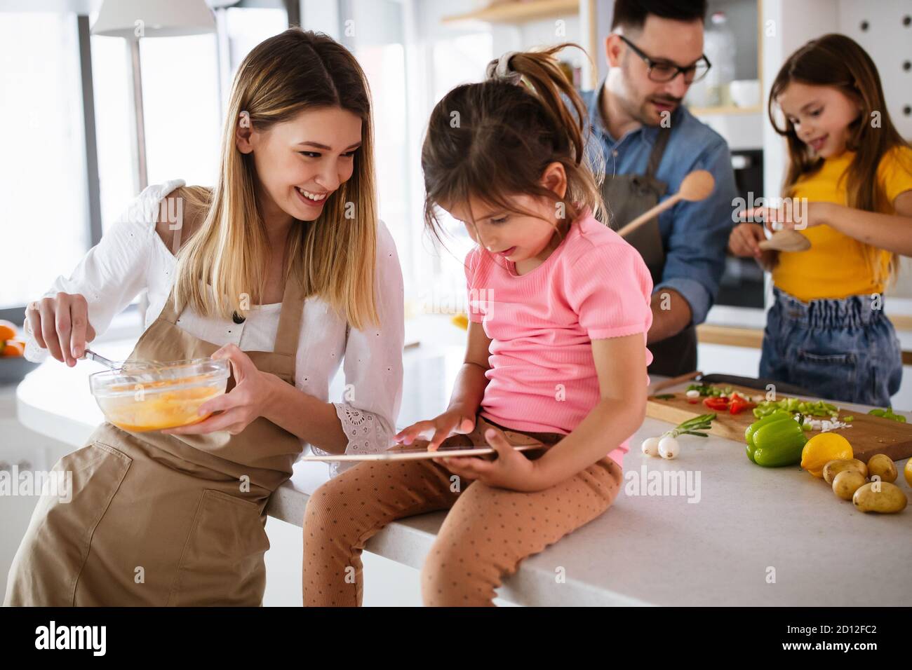 Happy family in the kitchen having fun and cooking together. Healthy ...