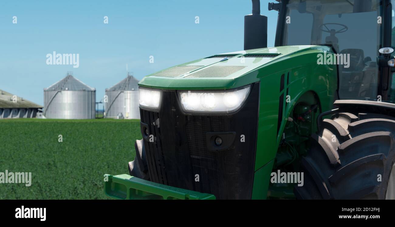 Red tractor on a agricultural field Stock Photo - Alamy
