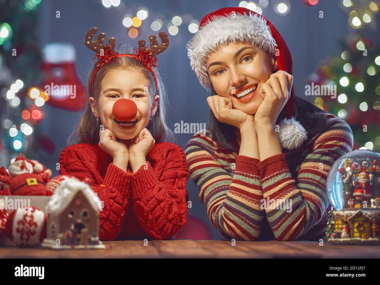 Merry Christmas and Happy Holiday! Mom and daughter near the tree at ...