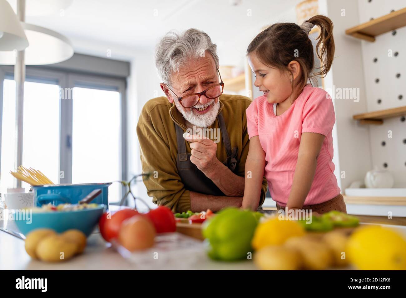 Grandchildren having fun at home while playing with their grandparents ...