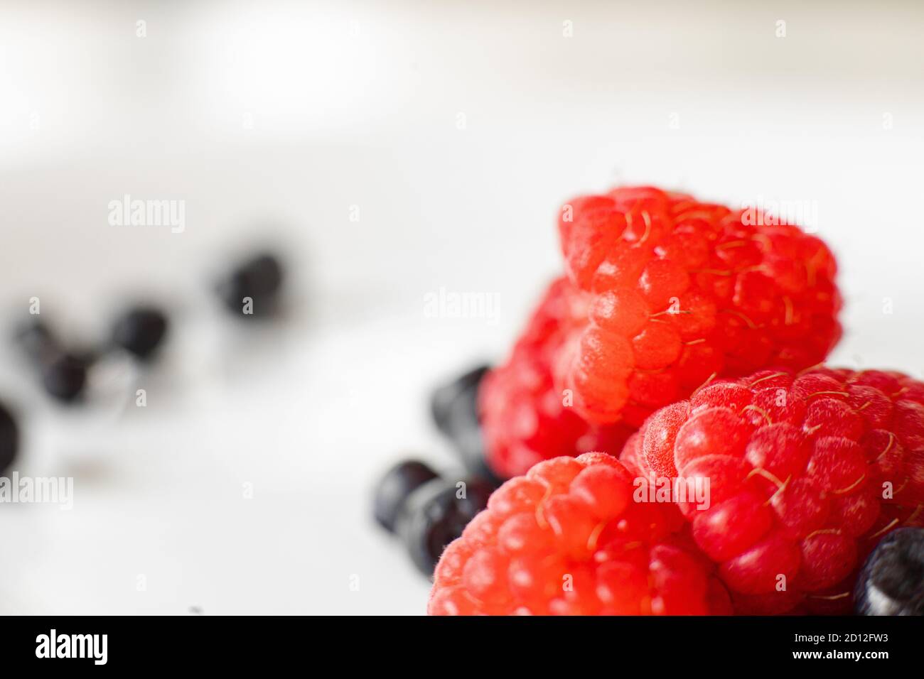 Black currant and raspberries pile Stock Photo - Alamy