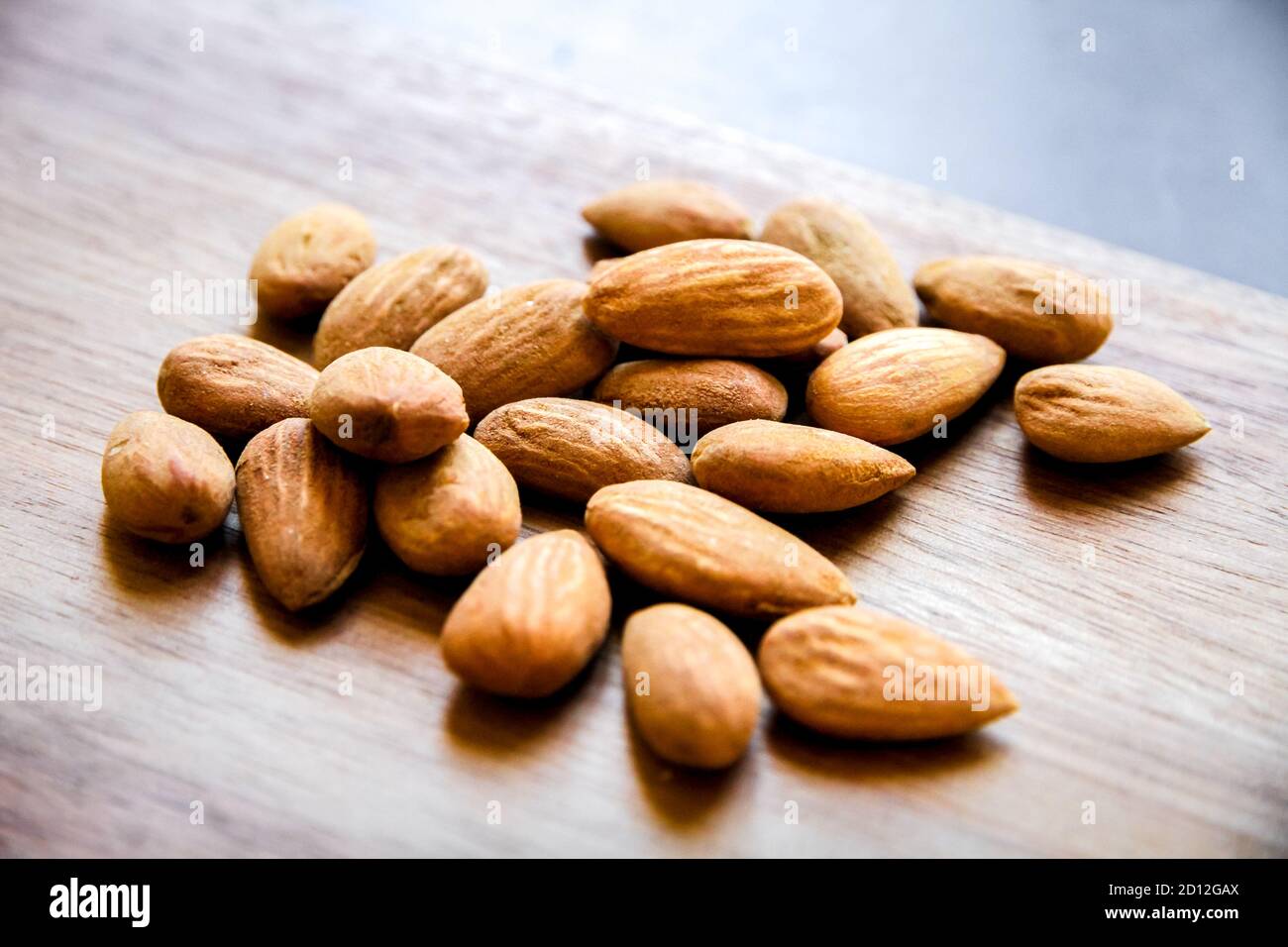 Fresh organic almonds on a wooden cutting board Stock Photo - Alamy