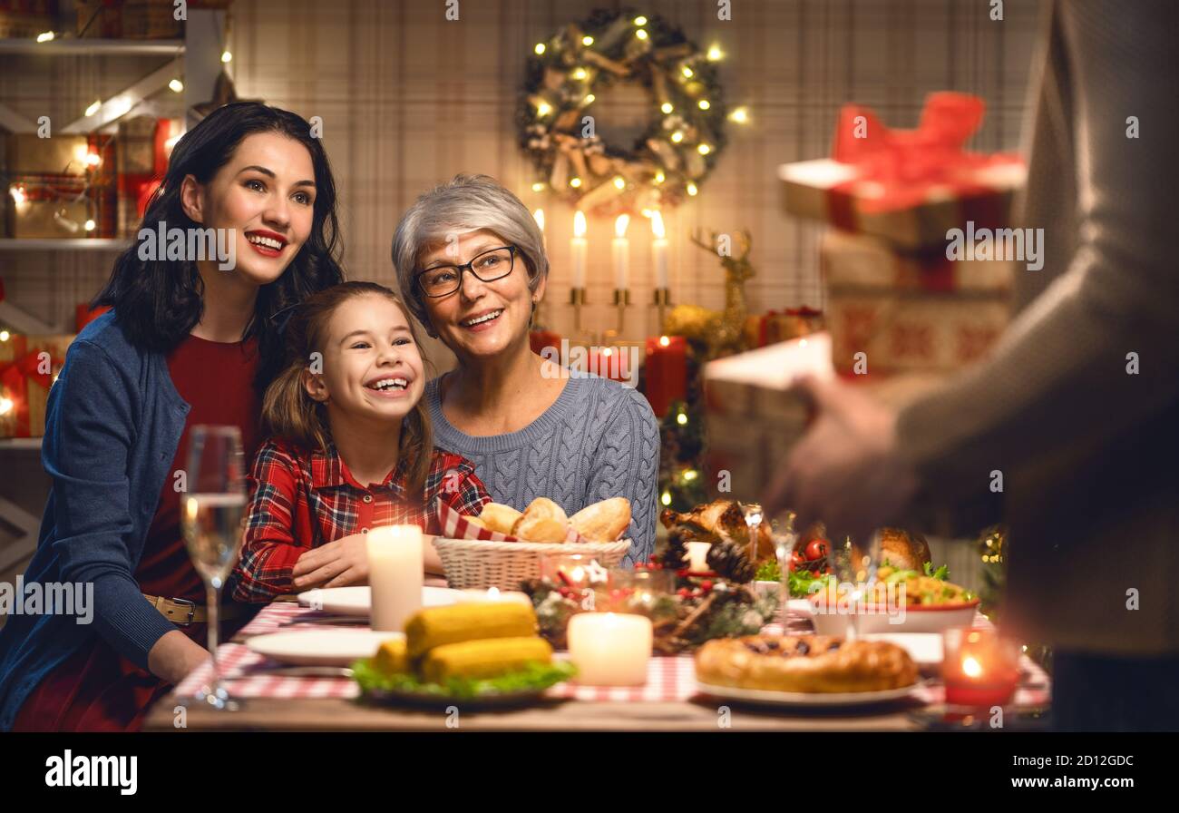 Merry Christmas! Happy family are having dinner at home. Celebration holiday and togetherness ...