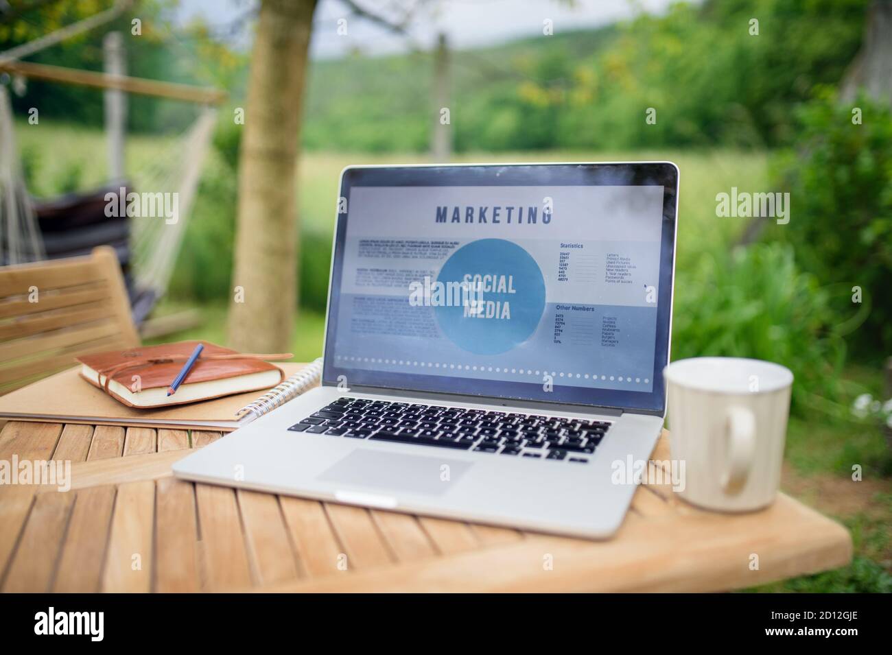Laptop on desk outdoors in garden, home office concept Stock Photo - Alamy