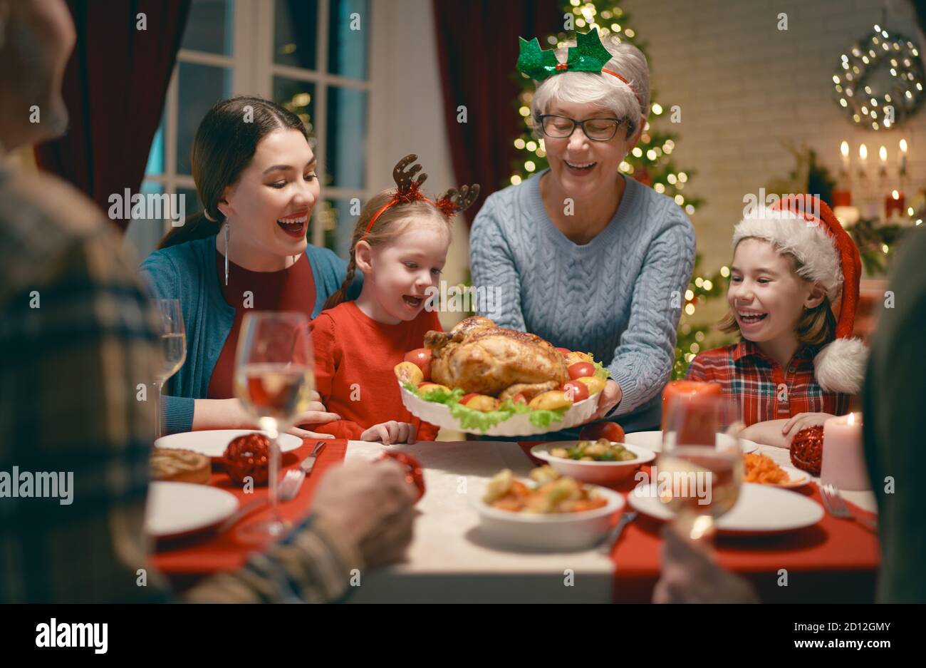 Merry Christmas! Happy family are having dinner at home. Celebration holiday and togetherness ...