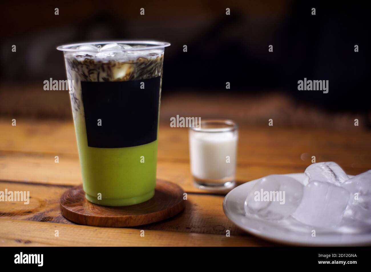 guava ice with a mixture of milk and grass jelly with a dark background ...