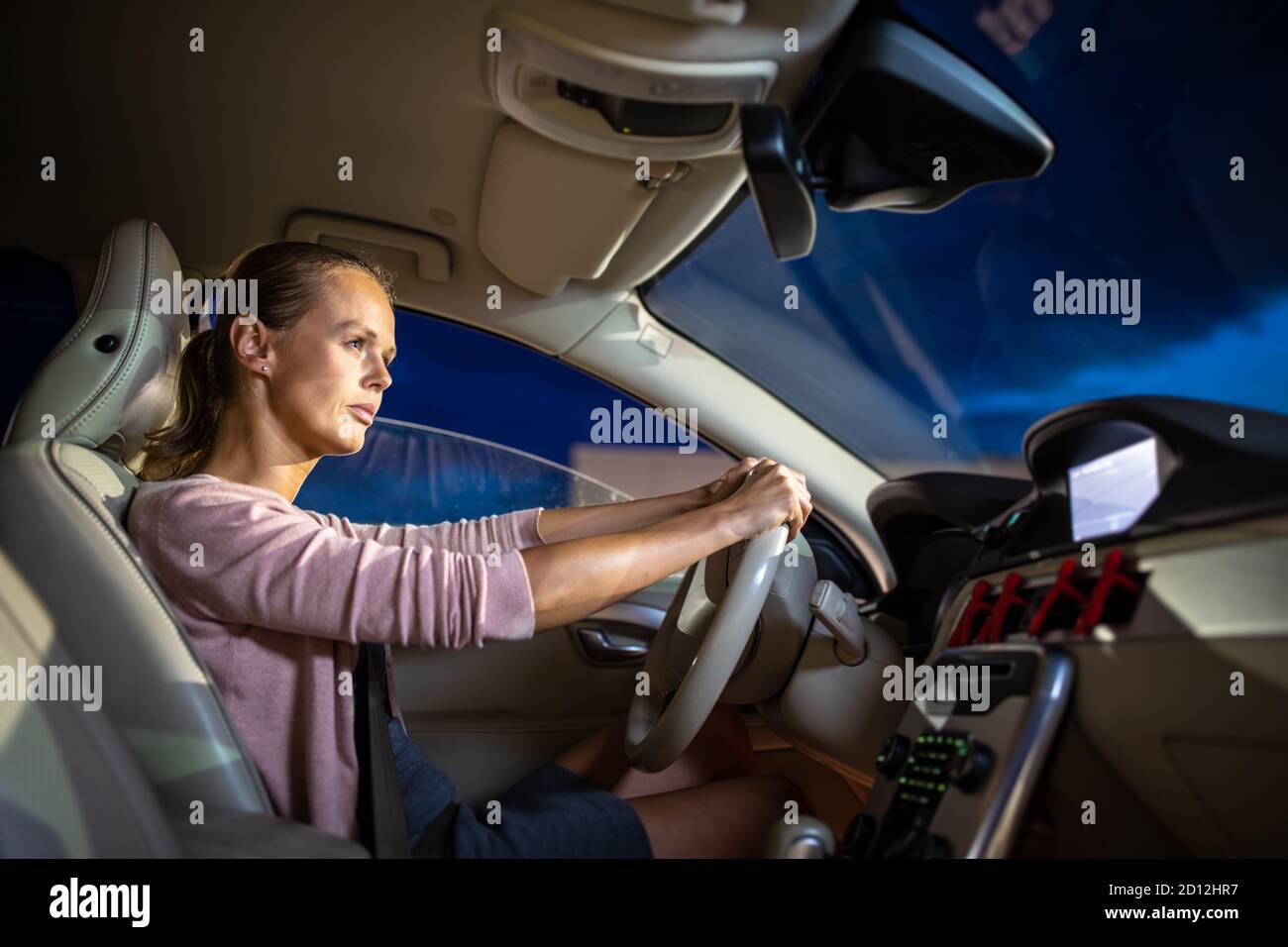 Young female driver at the wheel of her car - Road safety concept Stock ...