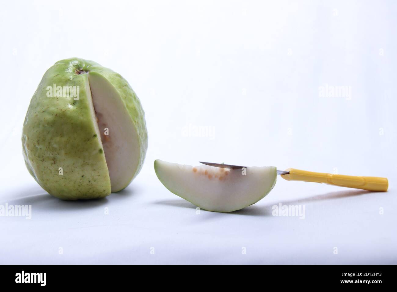 small knife and fresh white guava pieces with insulated white ...