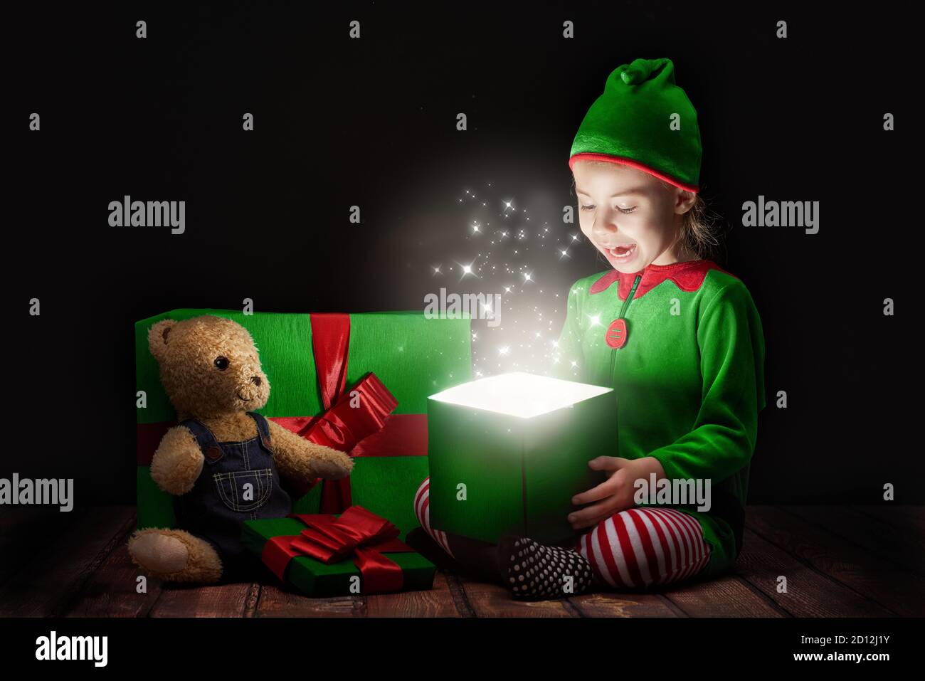 Cute little girl opening a magic gift box Stock Photo - Alamy