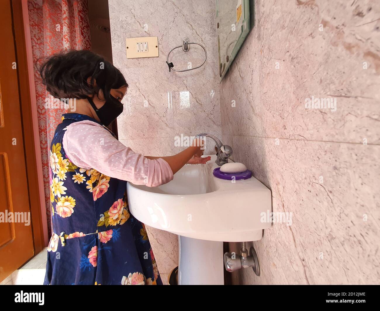 Washing hands in bathroom by masked Children during coronavirus ...