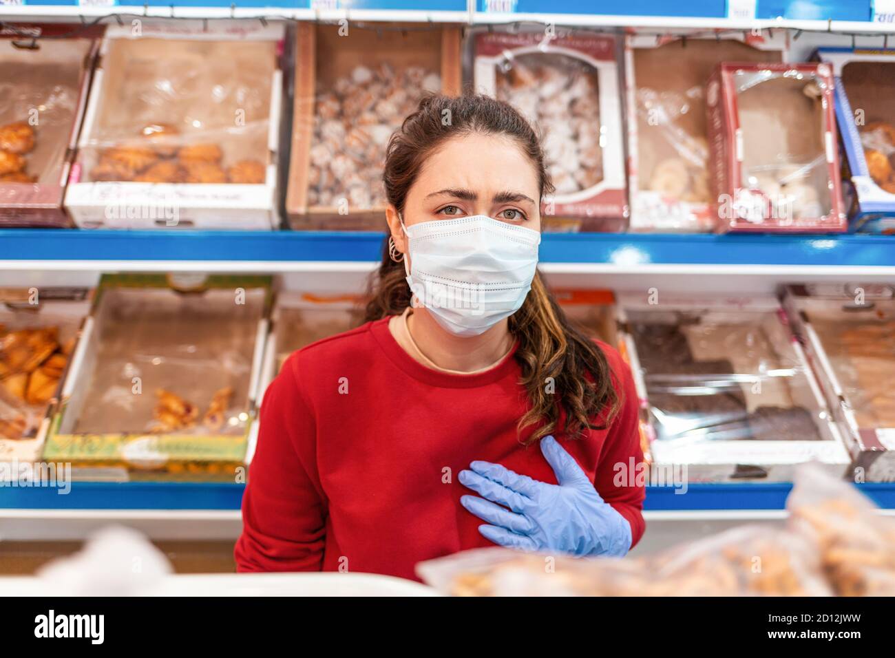 Symptoms of infection. A woman in rubber gloves and a medical mask on ...