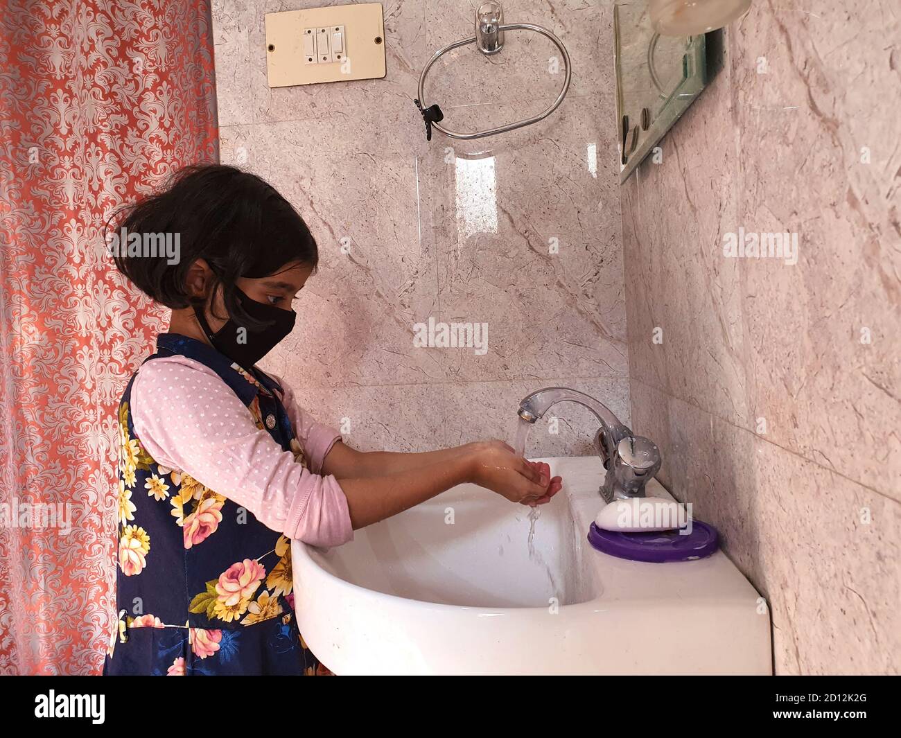 Washing hands in bathroom by masked Children during coronavirus ...