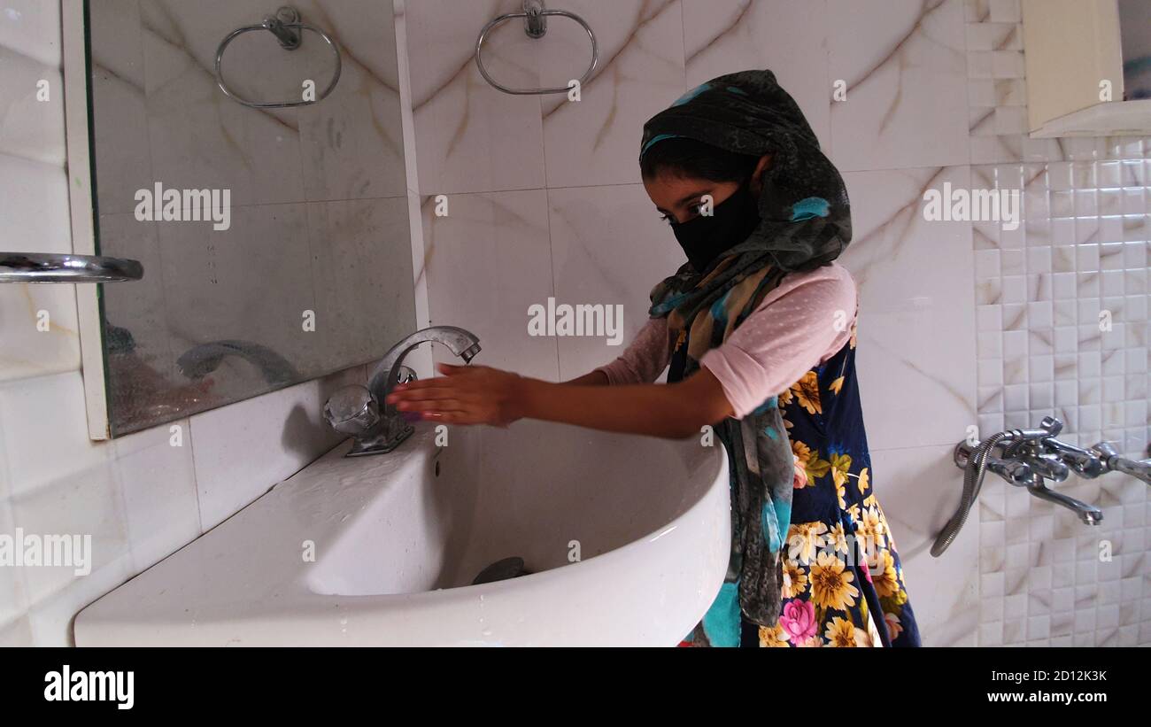 Washing hands in bathroom by masked Children during coronavirus ...