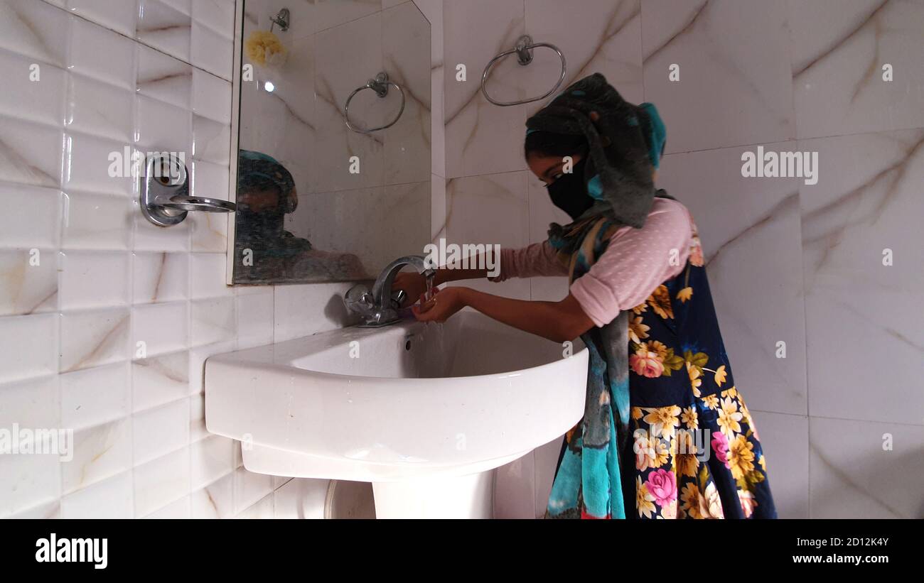 Washing hands in bathroom by masked Children during coronavirus ...