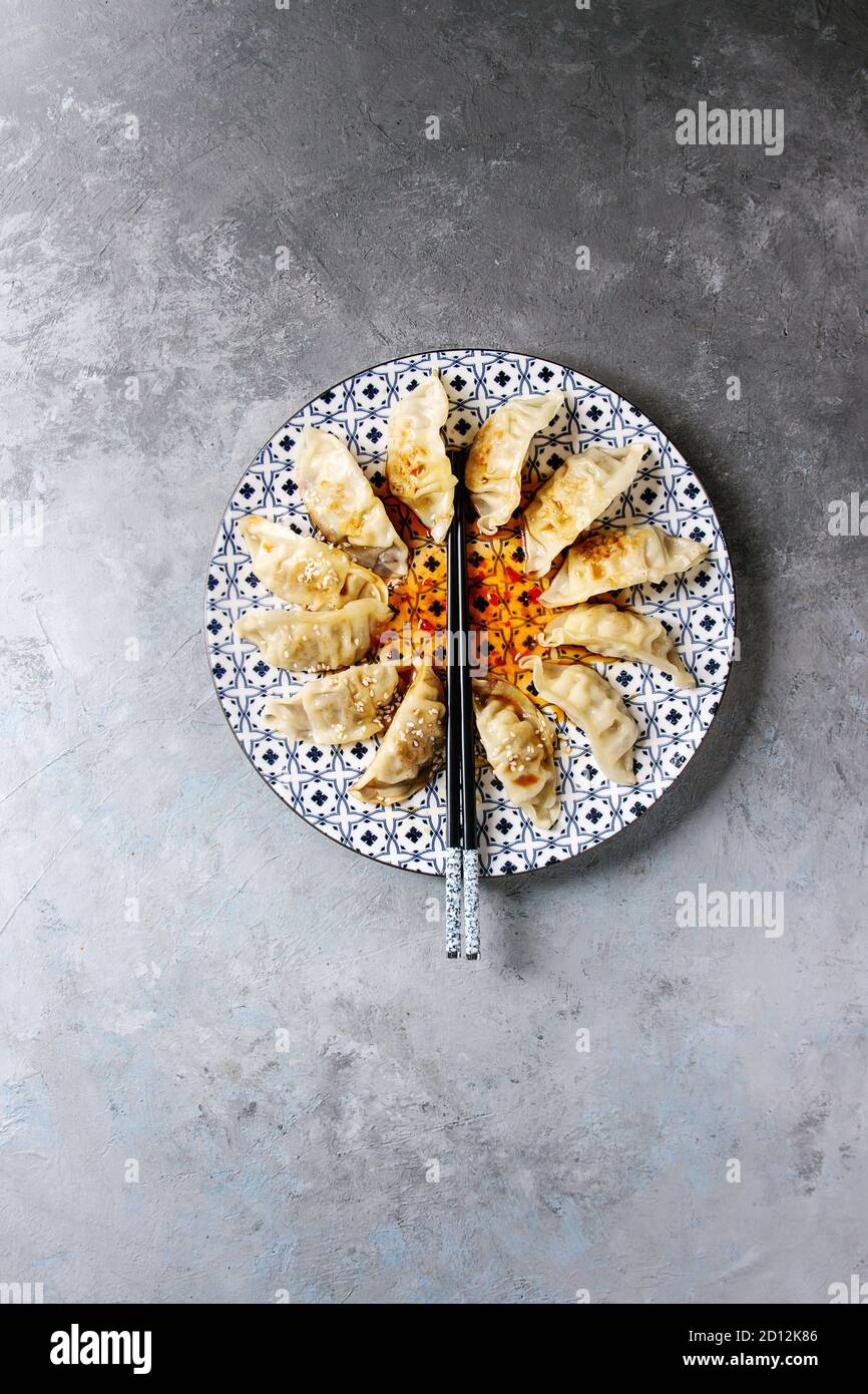 Asian dumplings Gyozas potstickers on white blue ceramic plate served ...