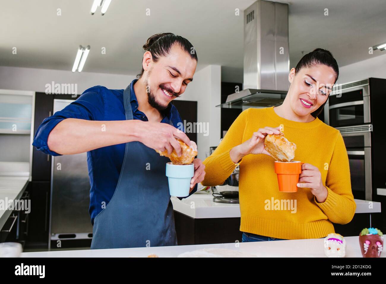 Mexican people baking and eating bread called pan de muerto traditional ...