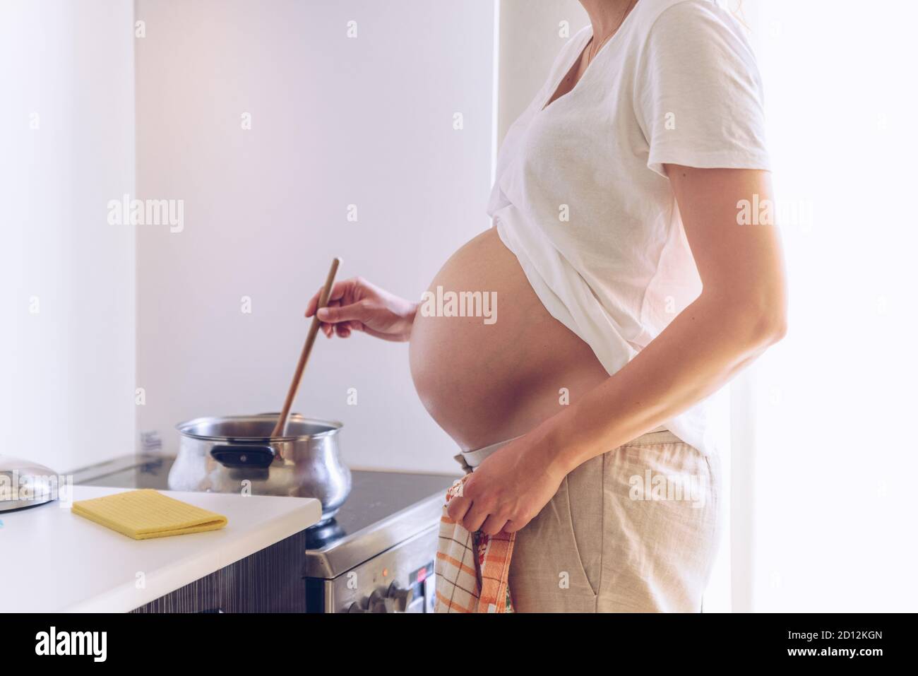 Pregnant cooking in her home Stock Photo - Alamy