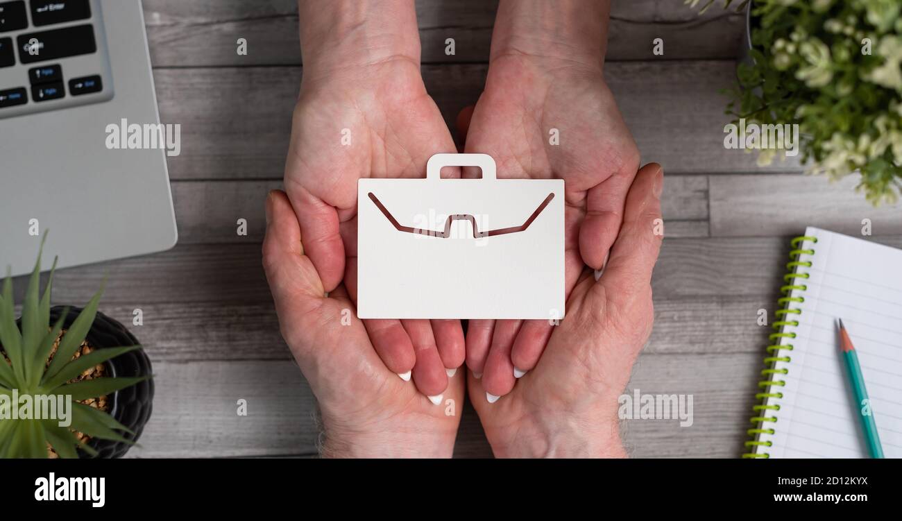 Concept of job loss insurance with paper briefcase in hands Stock Photo ...