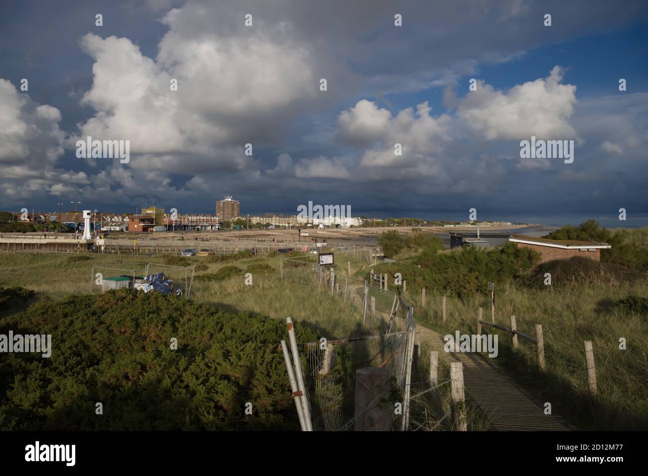 View of Littlehampton Seafront from the sand dunes as the sky darkens ...