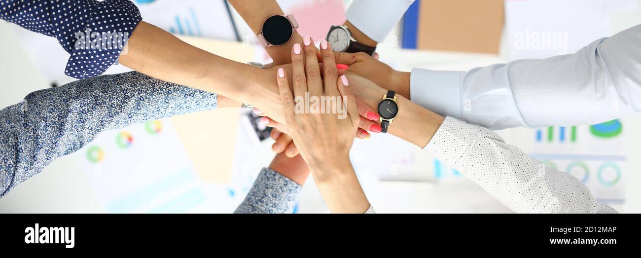 Business people hold their hands over the table in lock Stock Photo - Alamy