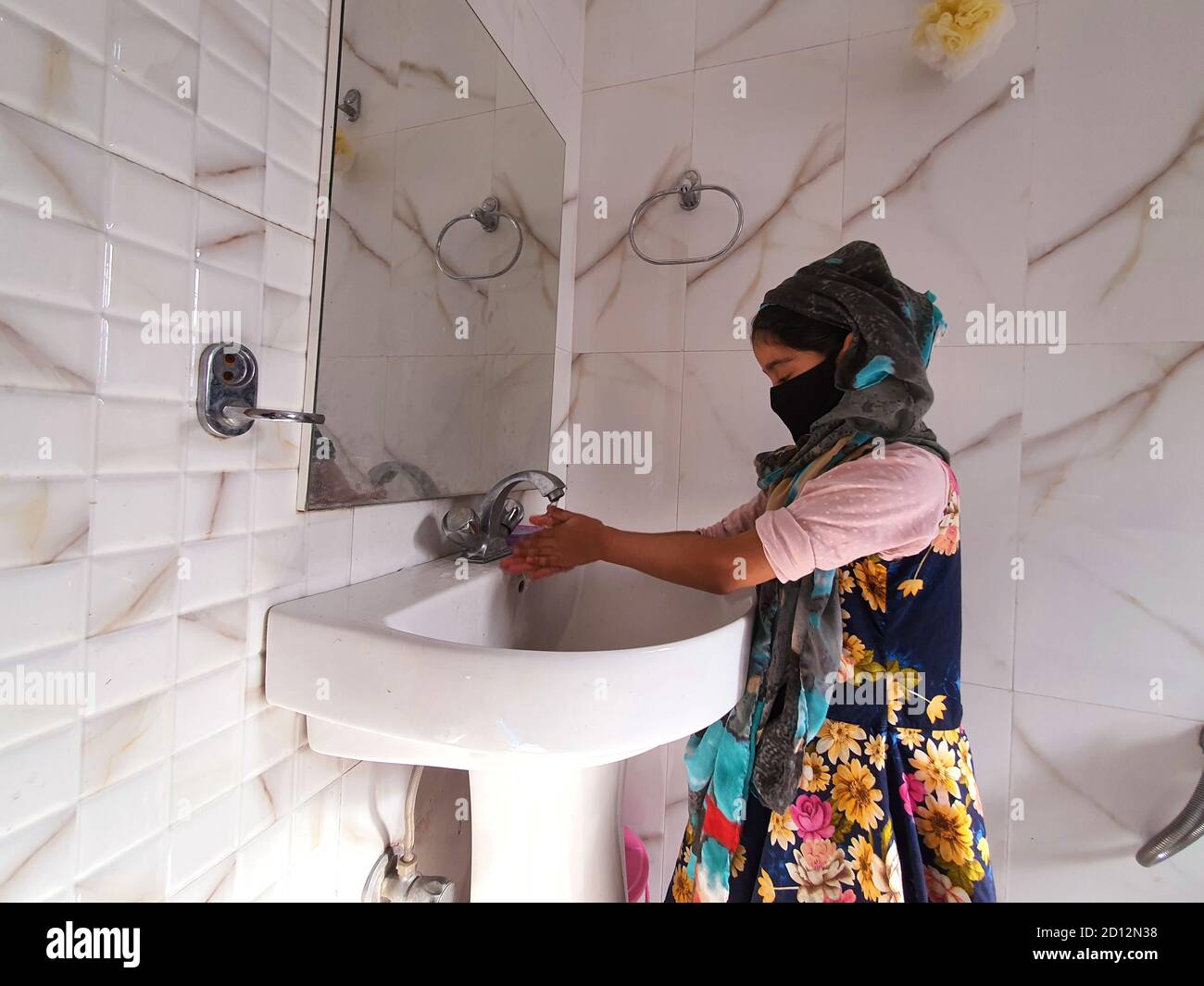 Washing hands in bathroom by masked Children during coronavirus ...