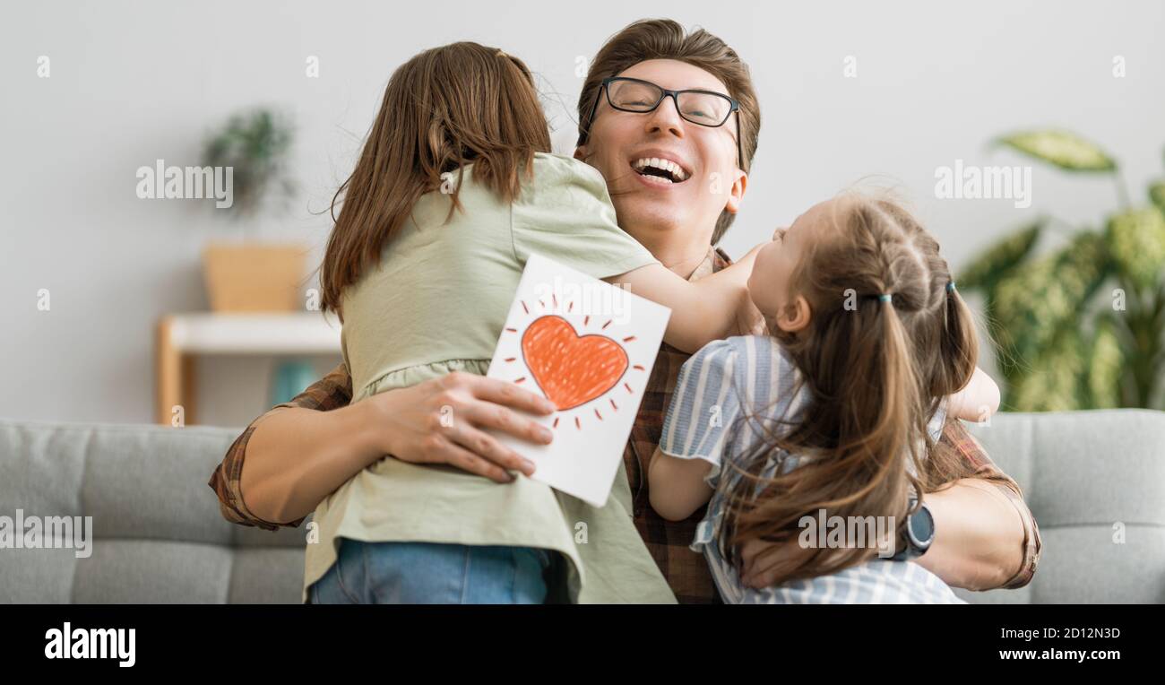 Happy father's day! Children daughters congratulating dad and giving ...