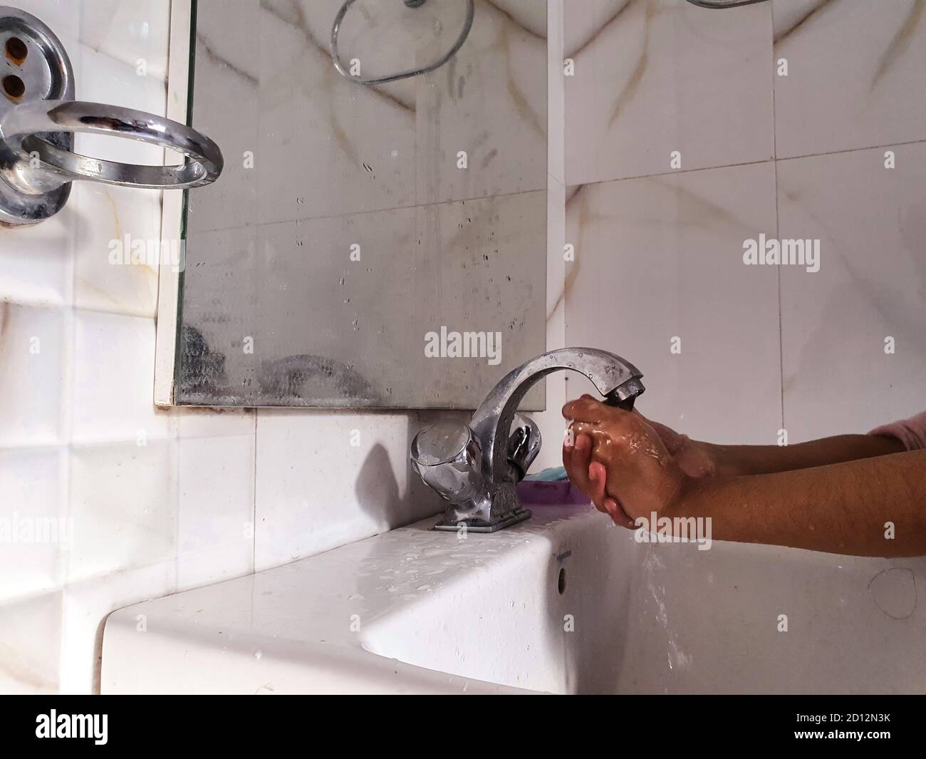 Washing hands in bathroom by masked Children during coronavirus ...