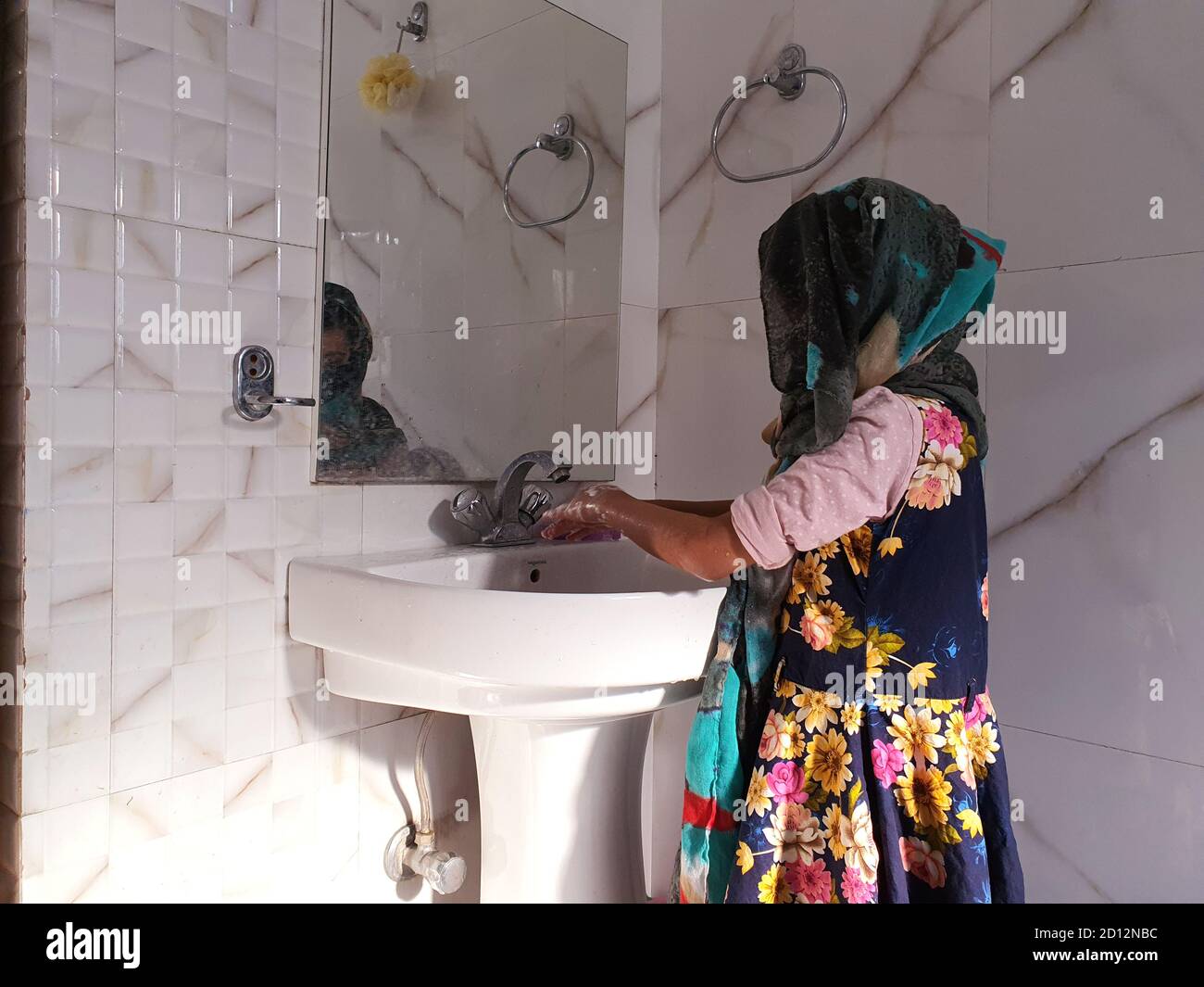 Washing hands in bathroom by masked Children during coronavirus ...