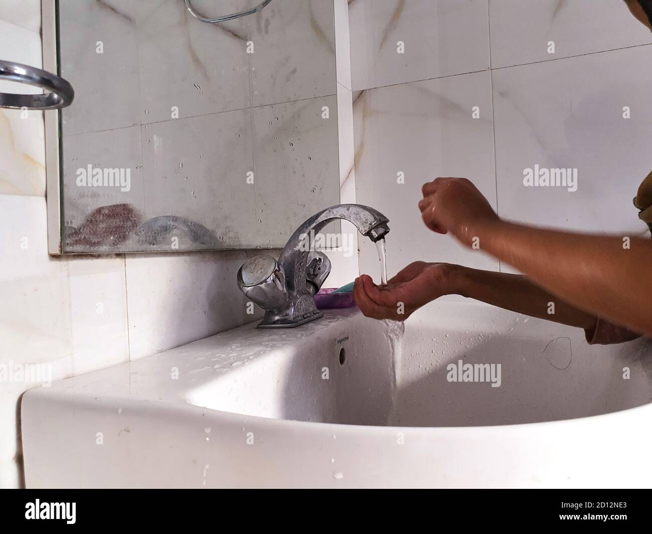 Washing hands in bathroom by masked Children during coronavirus ...