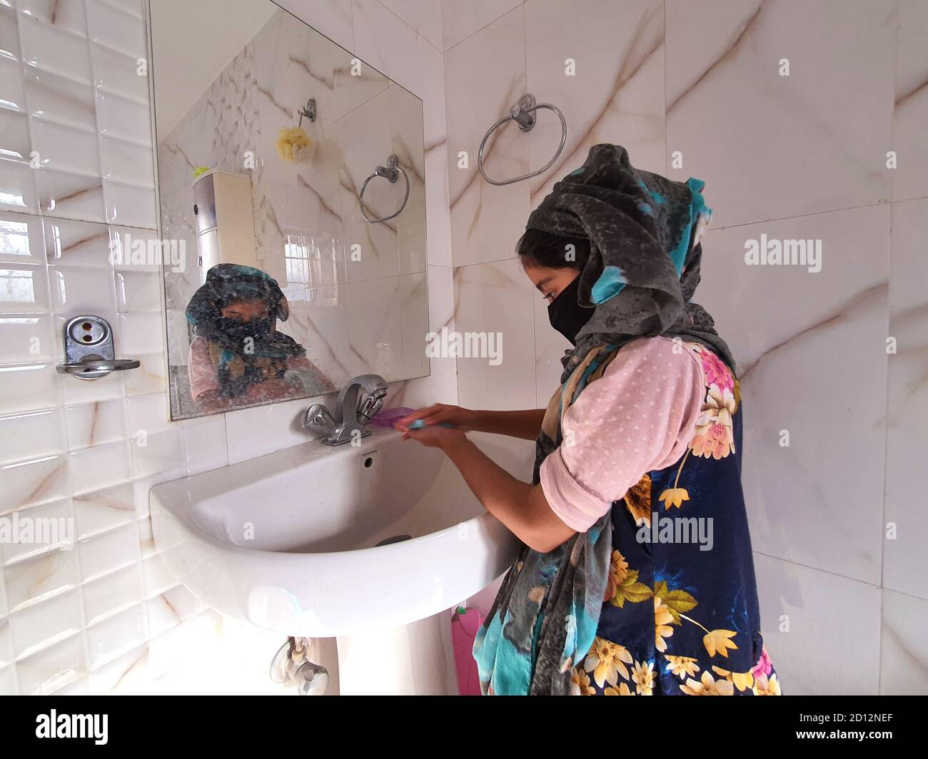 Washing hands in bathroom by masked Children during coronavirus ...