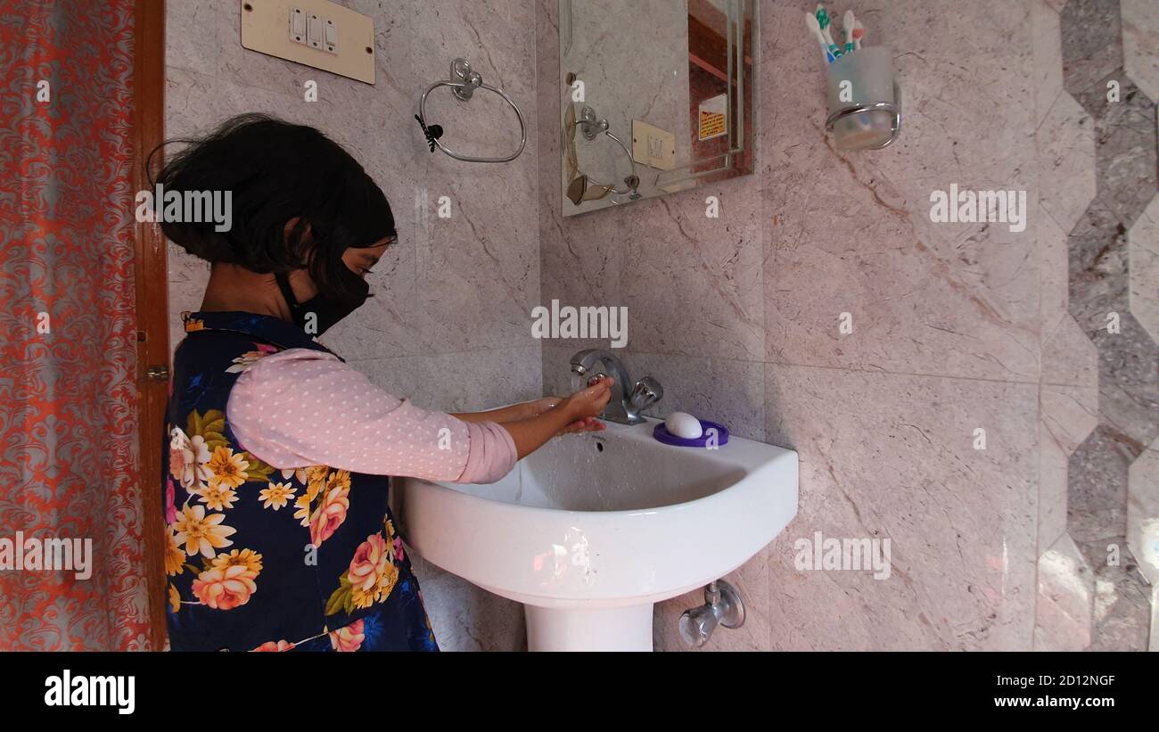 Washing hands in bathroom by masked Children during coronavirus ...