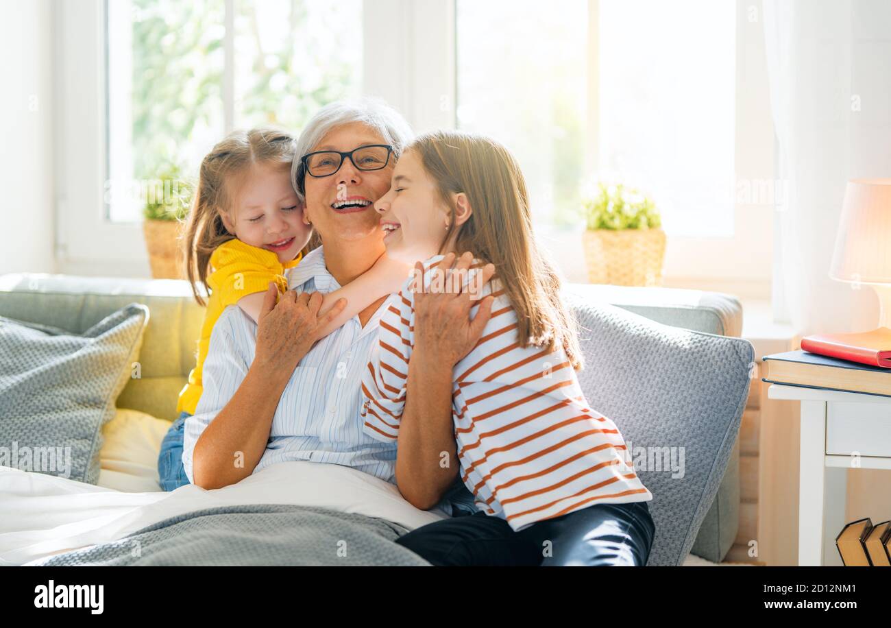 Nice girls and their grandmother enjoying sunny morning. Good time at ...
