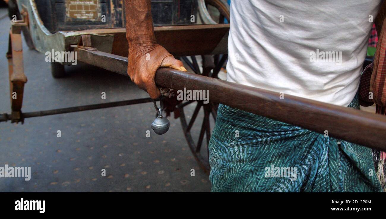 hand of rickshaw puller with bell ,in the street of Kolkata -India ...