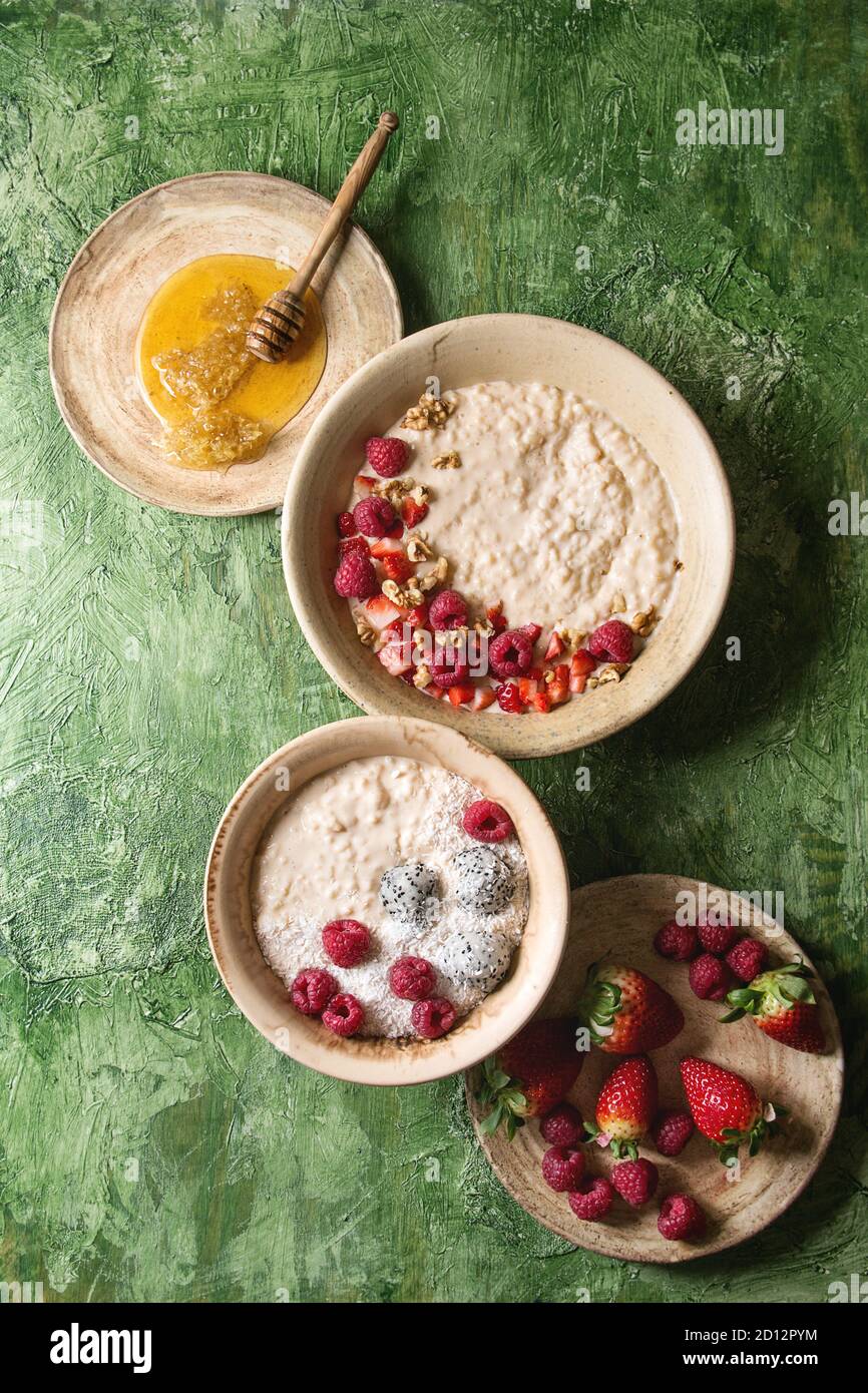 Sweet rice porridge pudding in ceramic plate with berries strawberry ...