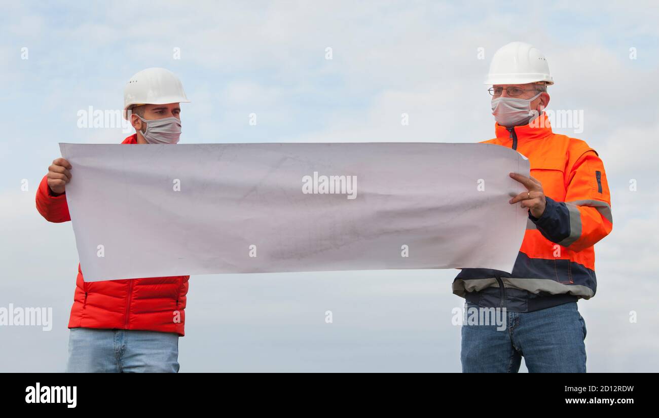 Construction workers talking construction site hi-res stock photography ...