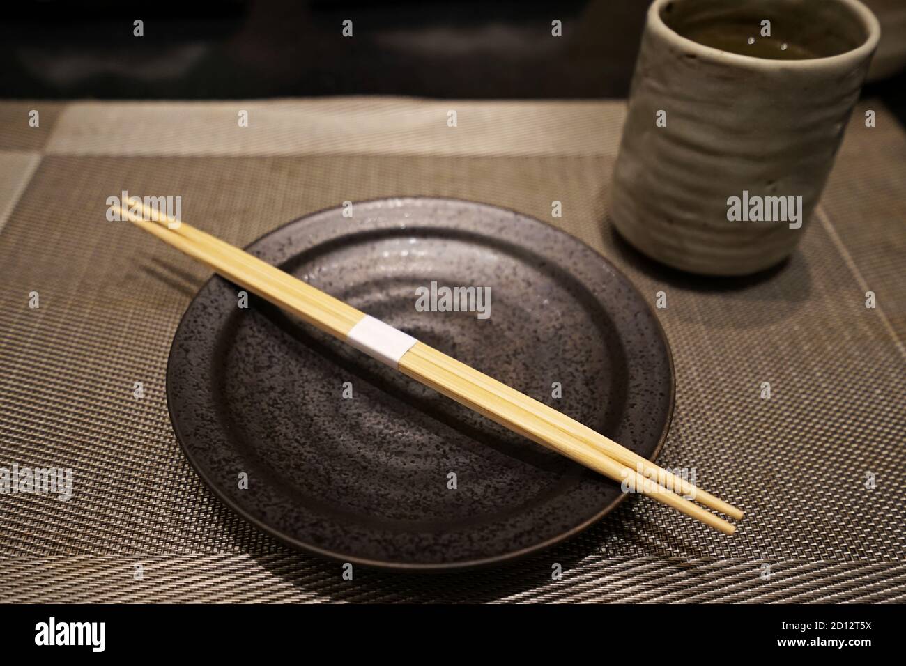 Close up Wooden chopsticks on ceramic plate Stock Photo - Alamy