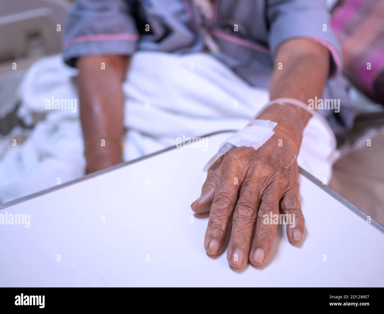 Saline solution drip on old women hand in hospital. Health care and ...