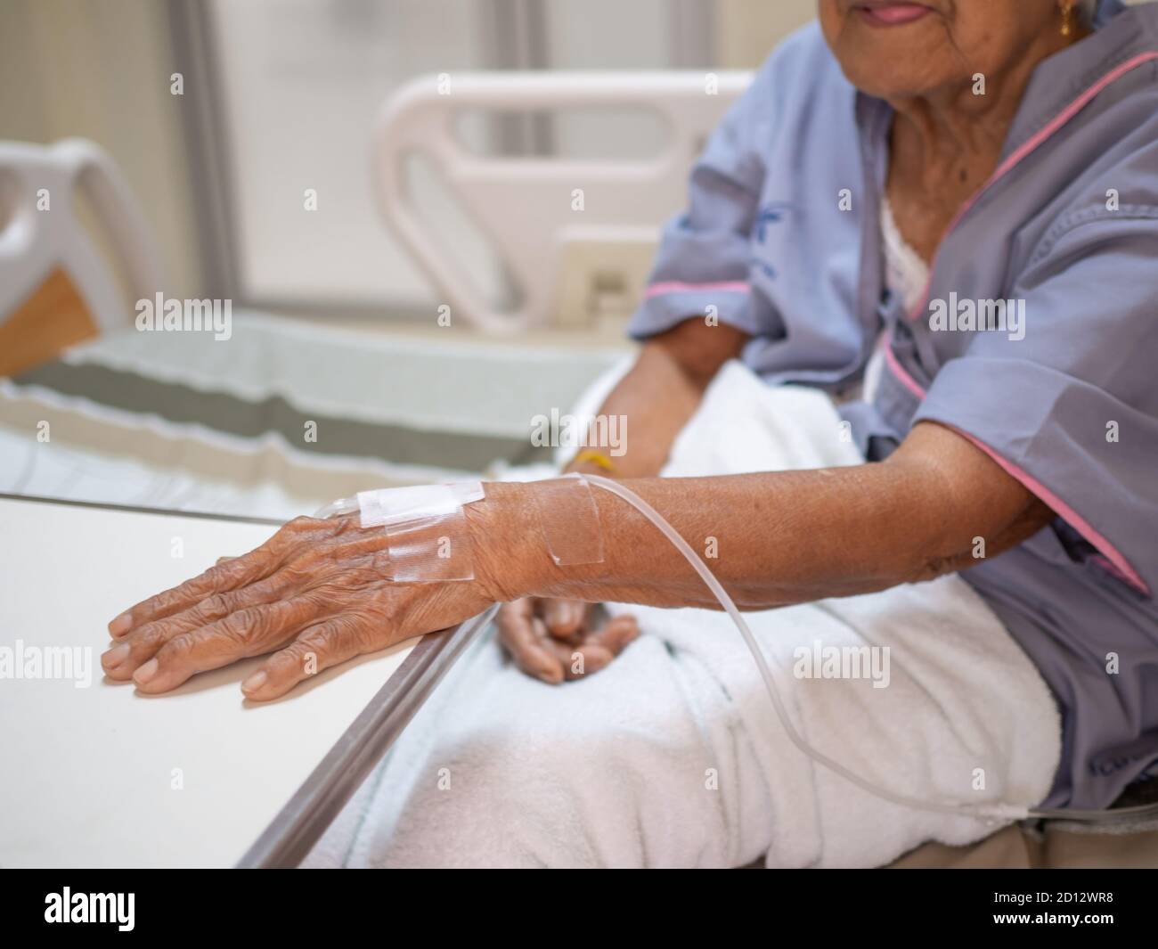 Saline solution drip on old women hand in hospital. Health care and ...