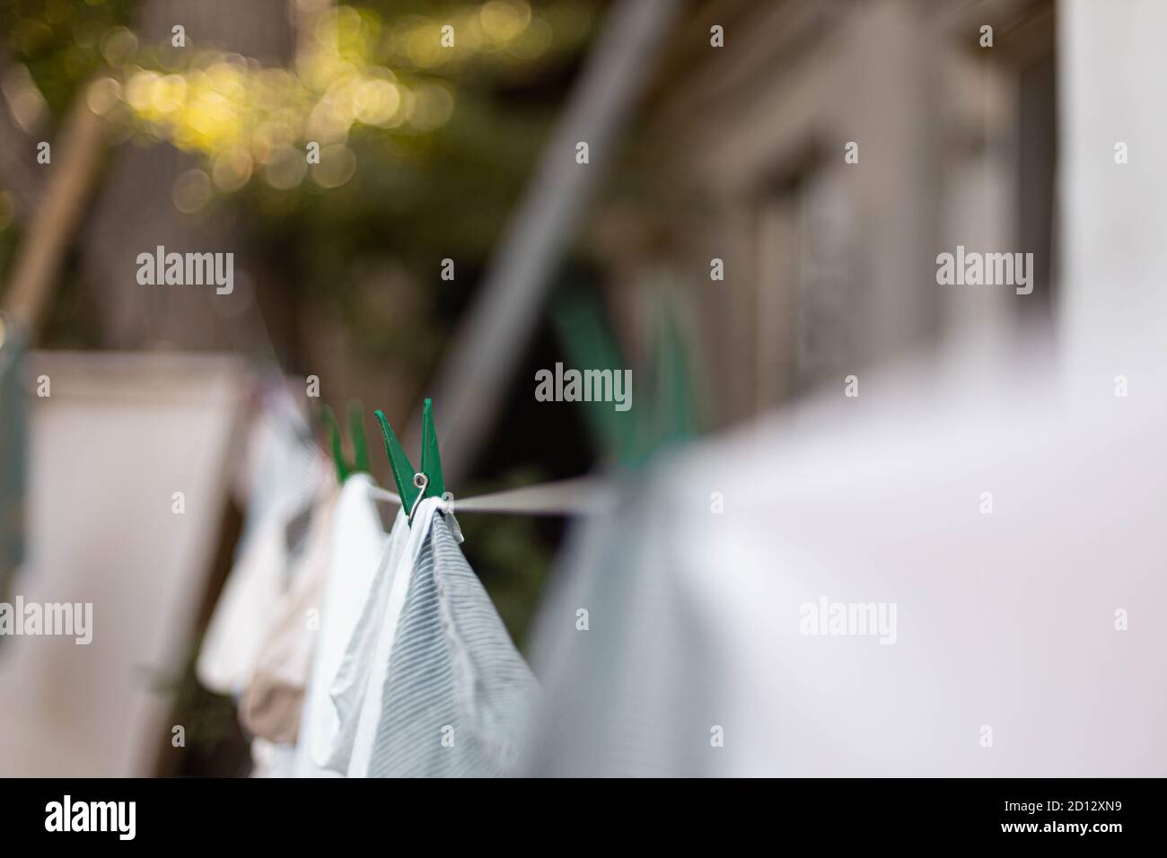 Close up of fresh clean white laundry drying on washing line in outdoor ...