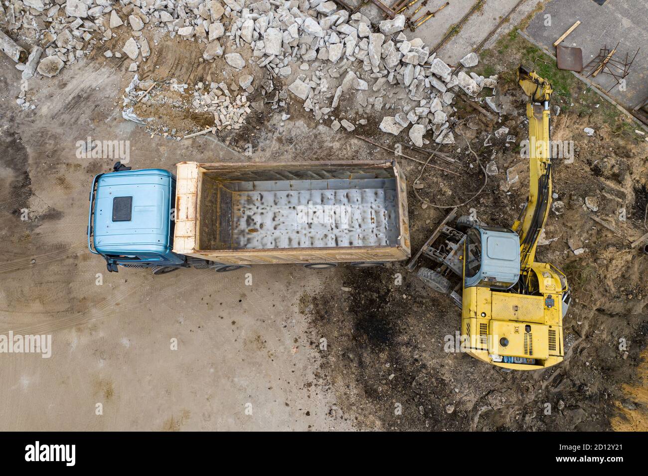 excavator loads sand in a truck top view Stock Photo - Alamy