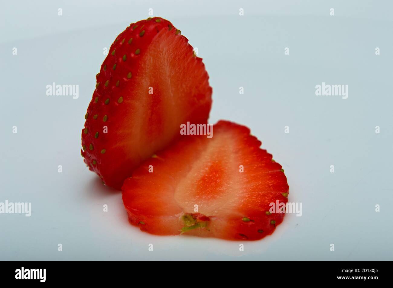 Two slices of a Strawberry Stock Photo - Alamy