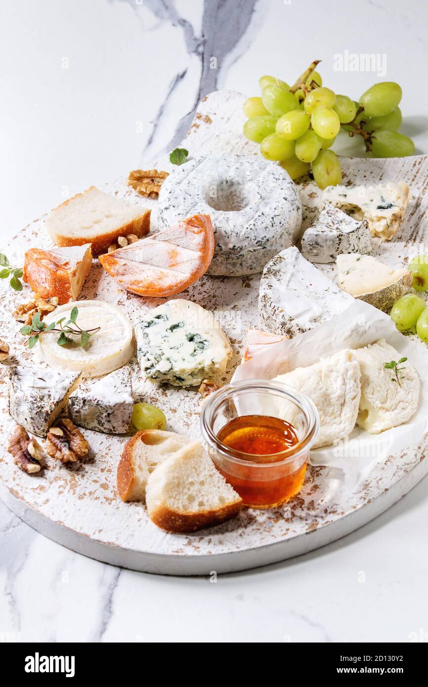 Cheese plate assortment of french cheese served with honey, walnuts ...