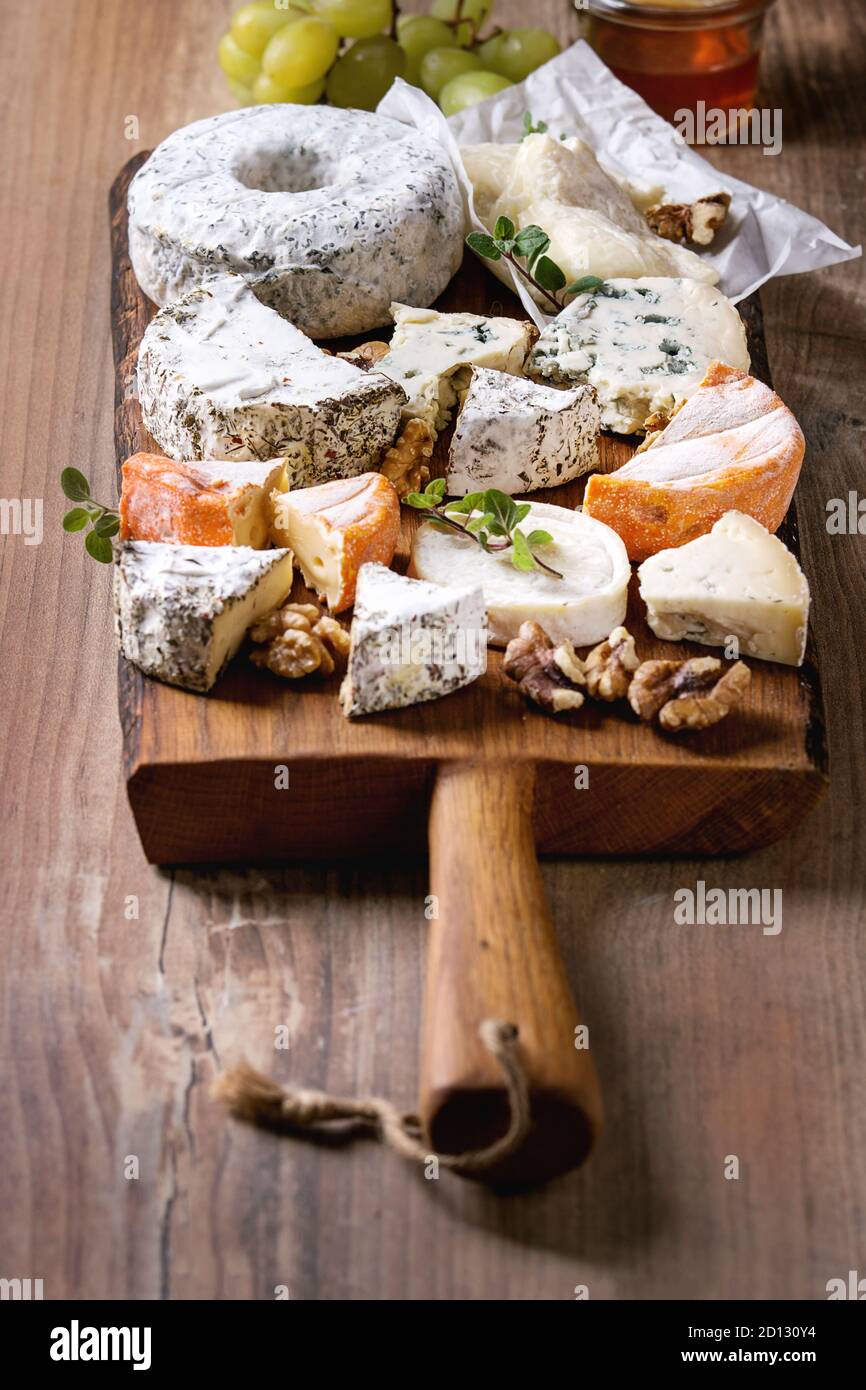 Cheese plate assortment of french cheese served with honey, walnuts ...