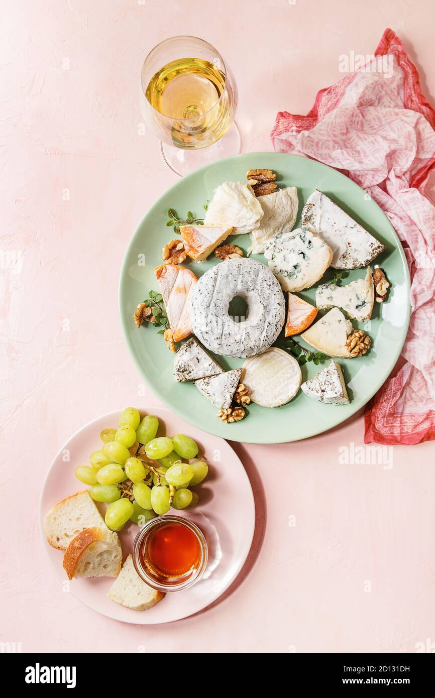 Cheese plate assortment of french cheese served with honey, walnuts ...